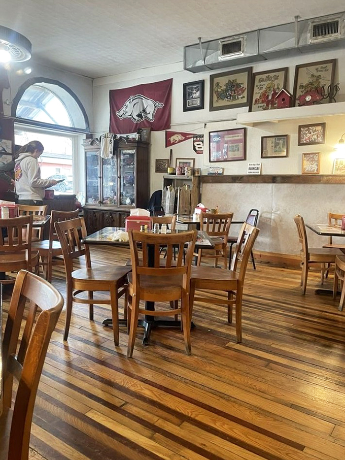 Arkansas pride adorns the walls, where Razorback red meets golden hardwood floors in a space that feels like your favorite aunt's dining room.