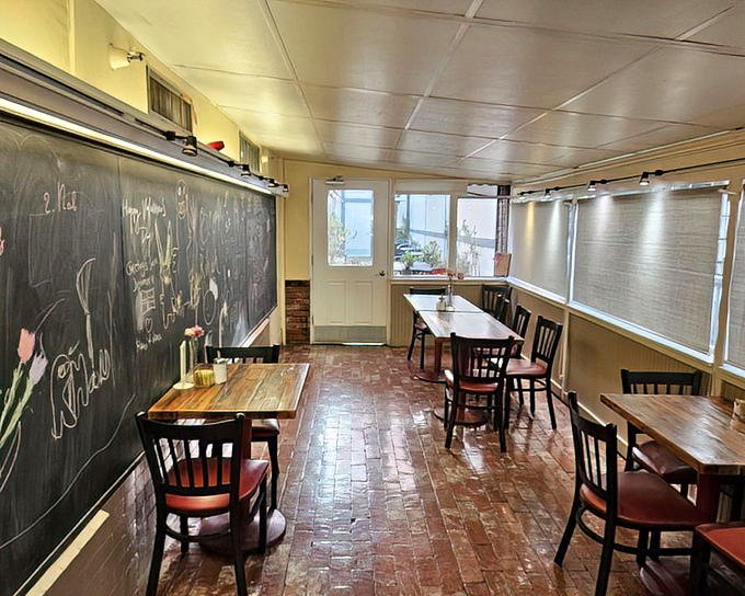 The dining area feels like your Danish grandmother's kitchen (if you had one)&mdash;brick floors, wooden tables, and a chalkboard that probably holds secrets to happiness.