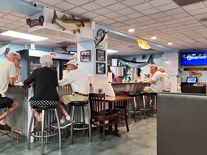 The counter seating &ndash; where regulars exchange fishing tales while waiting for their seafood fix. Notice nobody's looking at their phones.