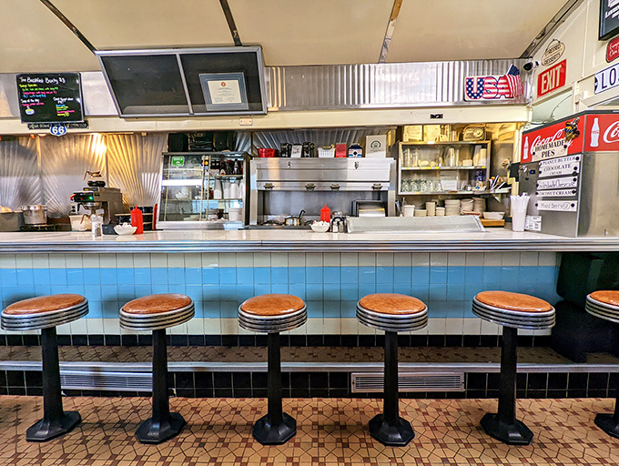 That blue-tiled counter has witnessed countless cups of coffee, first dates, and the morning paper ritual for generations.