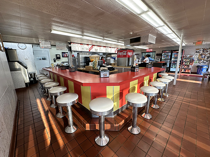The counter where magic happens&mdash;red and yellow like a vintage carnival, with stools that have supported generations of happy eaters.