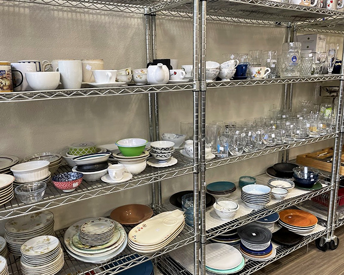 Plates and bowls in every imaginable style await their next dinner party. That floral pattern has seen some potlucks in its day.
