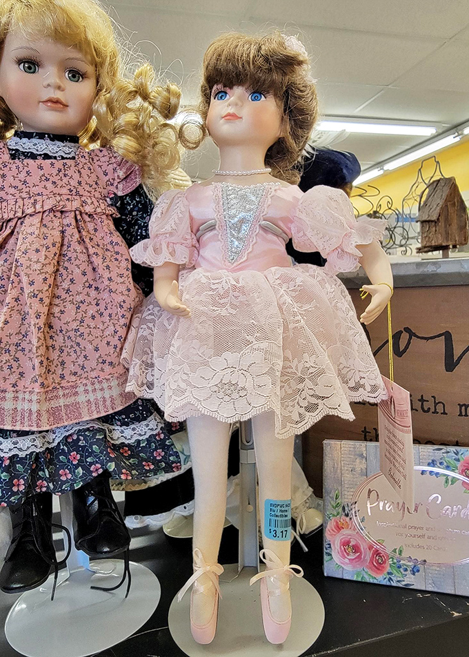 Porcelain memories line these shelves. These vintage dolls in delicate dresses wait patiently for collectors or a child's imaginative play.
