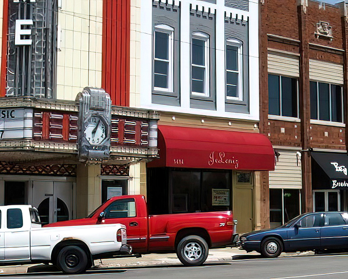 The Time Theater's vintage clock keeps watch over Broadway Avenue, where small businesses have outlasted big-box competition through sheer determination.