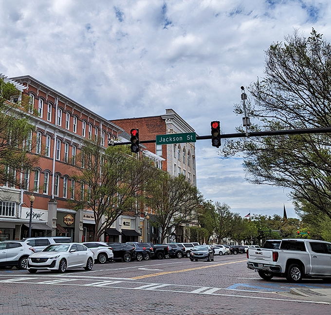 Broad Street buzzes with activity under Jackson Street's watchful traffic lights &ndash; the beating heart of Thomasville's vibrant downtown.