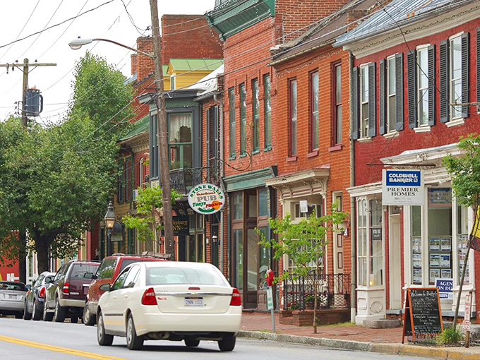 Red brick buildings line up like old friends sharing stories, their classic facades housing businesses that have evolved while honoring tradition.