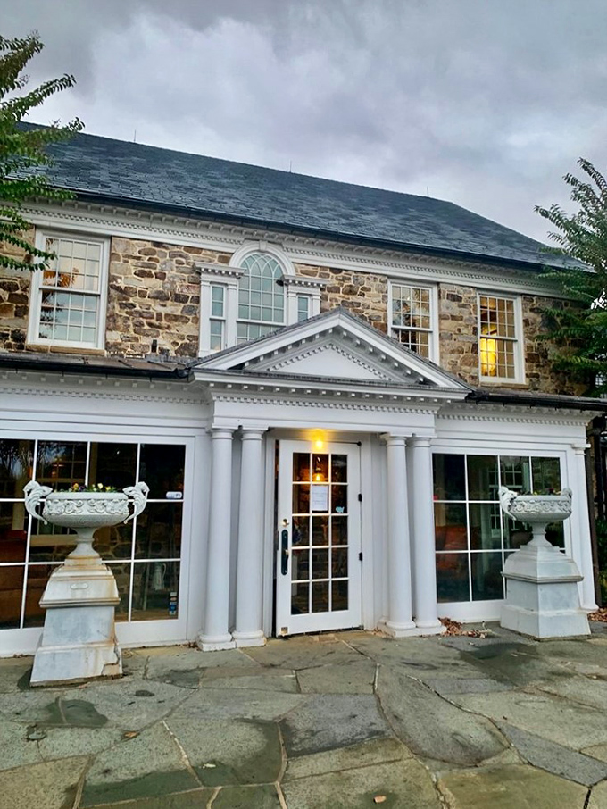 As dusk settles on the stone facade, the glowing windows promise warmth, hospitality, and a meal worth remembering.
