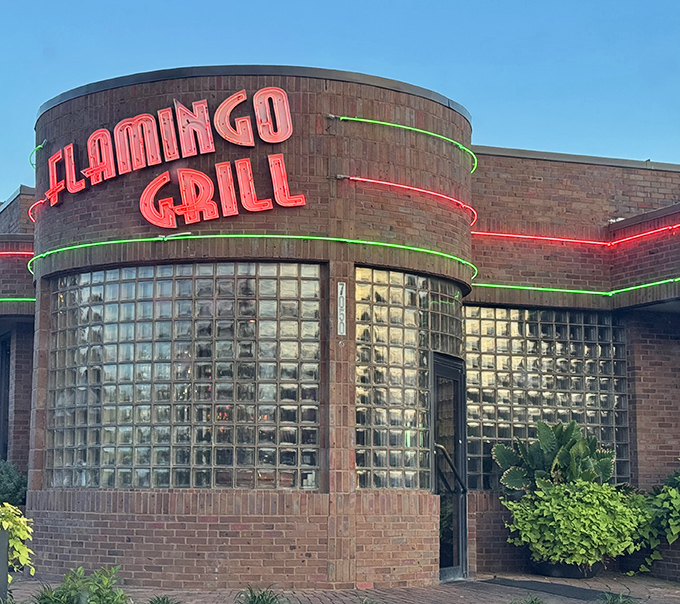 The neon-lit entrance glows like a beacon for hungry souls, promising refuge from chain restaurants and their laminated menus.