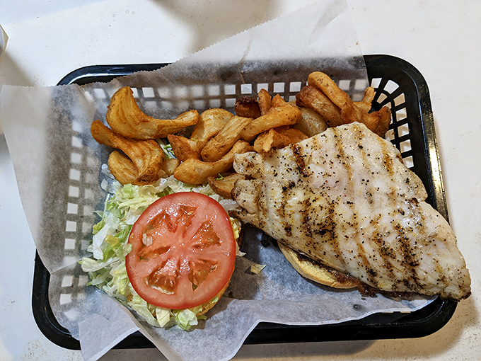 A perfectly grilled fish sandwich with crispy fries reminds you that straightforward beach food can be absolutely magnificent when done right.