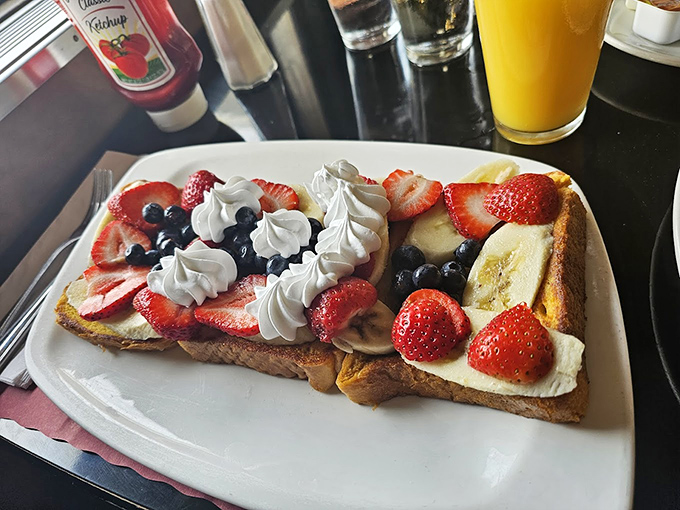 French toast that's crossed the line from breakfast to dessert, where fresh berries and whipped cream make you question why we ever settled for maple syrup alone.