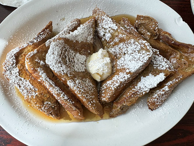 French toast that's dressed for success with powdered sugar and a dollop of butter melting into pure breakfast bliss.