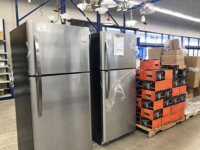Refrigerators and lighting fixtures cohabitate in this corner of appliance real estate, where ceiling glamour meets practical food preservation.