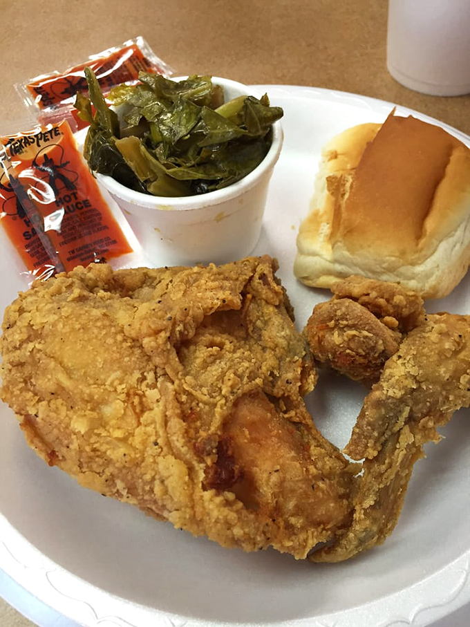 Soul on a plate. This fried chicken with collard greens and a buttery roll is what Southern grandmothers dream about when they fall asleep watching Jeopardy.