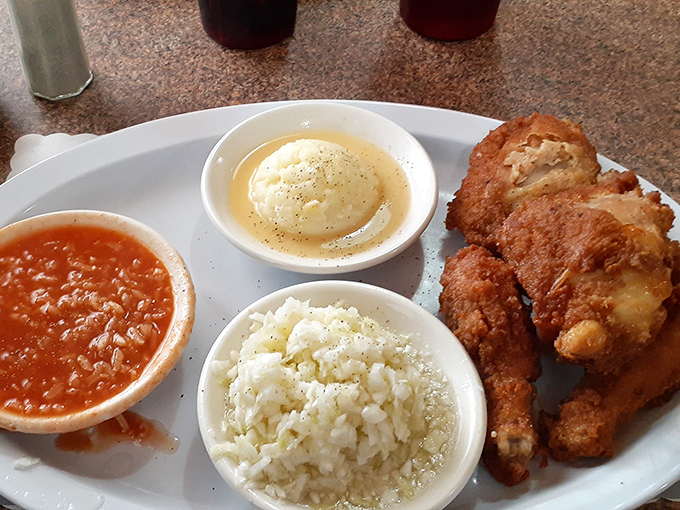 The holy trinity of Barberton dining: spicy tomato rice, creamy mashed potatoes, and chicken so perfectly fried it makes you question every other fried chicken you've ever eaten.