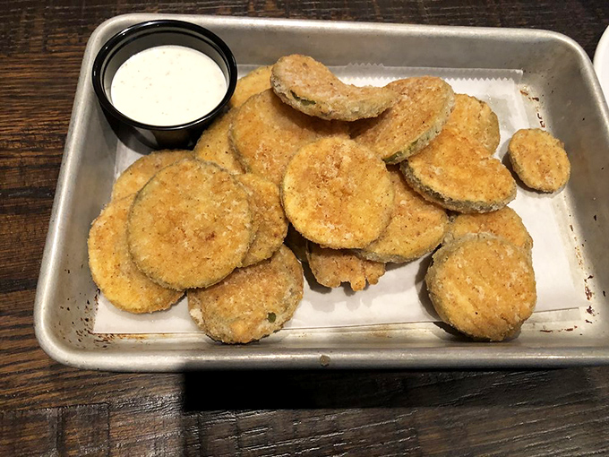 Fried pickles that achieve the impossible: maintaining their crunch while delivering that perfect vinegary bite beneath a golden coating.