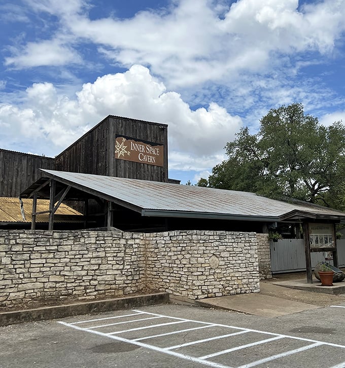 The rustic exterior blends with the Hill Country landscape, while that sign promises something far more exotic beneath your feet.