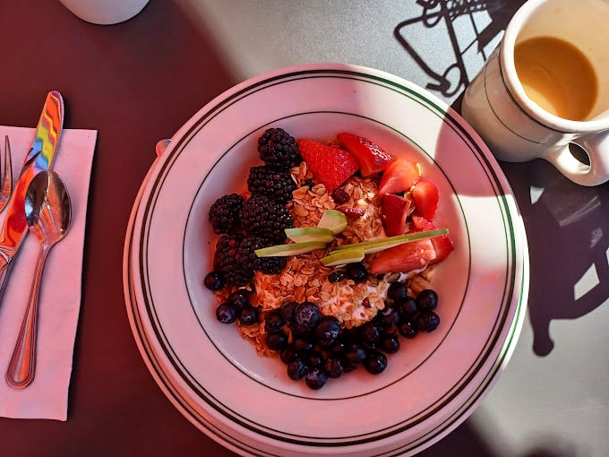 A breakfast masterpiece of fresh berries and granola that somehow makes virtue feel indulgent, especially with that coffee on standby.