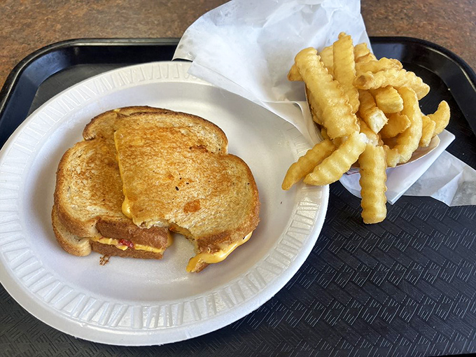A perfectly executed grilled cheese sandwich&mdash;proof that two slices of bread and melted American cheese can still be the ultimate comfort food.