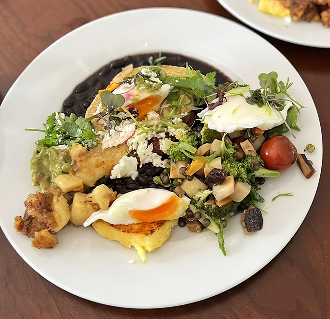 A fiesta on a plate! Black beans, fresh greens, eggs, and what appears to be perfectly ripe avocado&mdash;breakfast with no passport required.