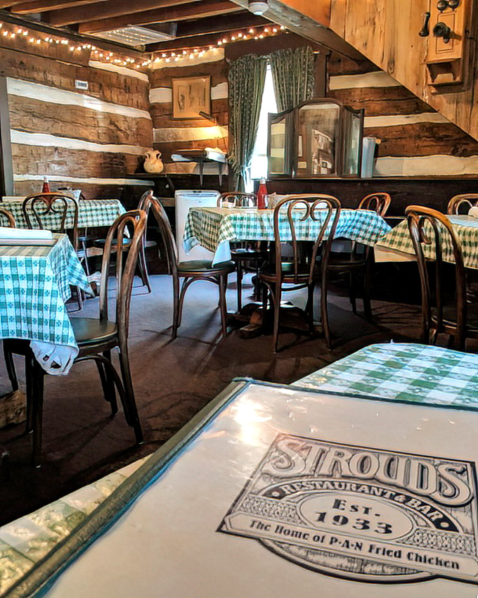 Log cabin walls and string lights create an atmosphere that says, "Stay awhile, have another cinnamon roll, we're not rushing you." 