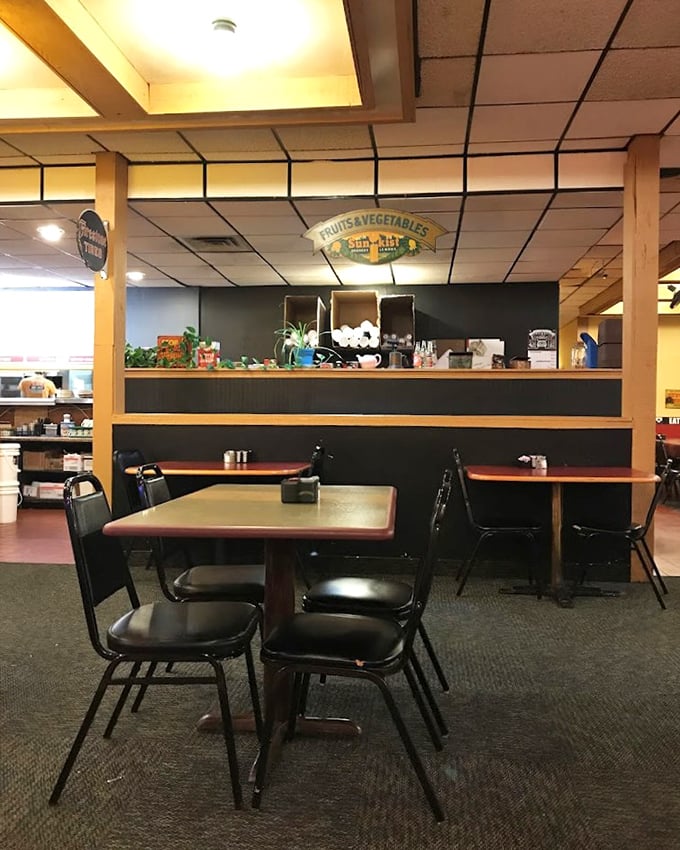 Simple tables await the next round of hungry diners. The "Fruits & Vegetables" sign might be the diner's best inside joke.