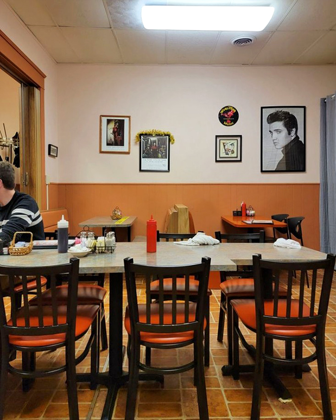 Simple tables where countless stories have been shared over bottomless coffee cups, beneath the watchful gaze of The King himself.