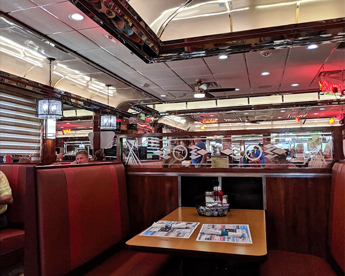 Red vinyl booths and mirrored walls create that classic diner atmosphere where every seat feels like the best seat in the house. 