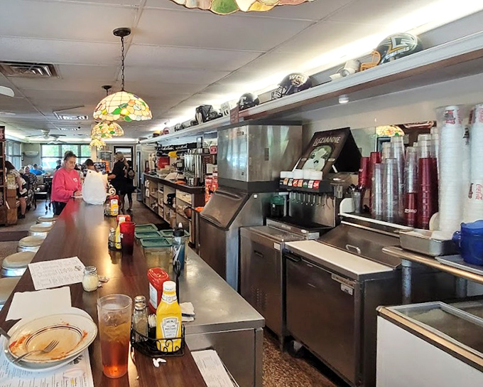 The bustling heart of Clyde's kitchen&mdash;where Tiffany-style lamps cast a warm glow over the choreographed dance of short-order cooking. 