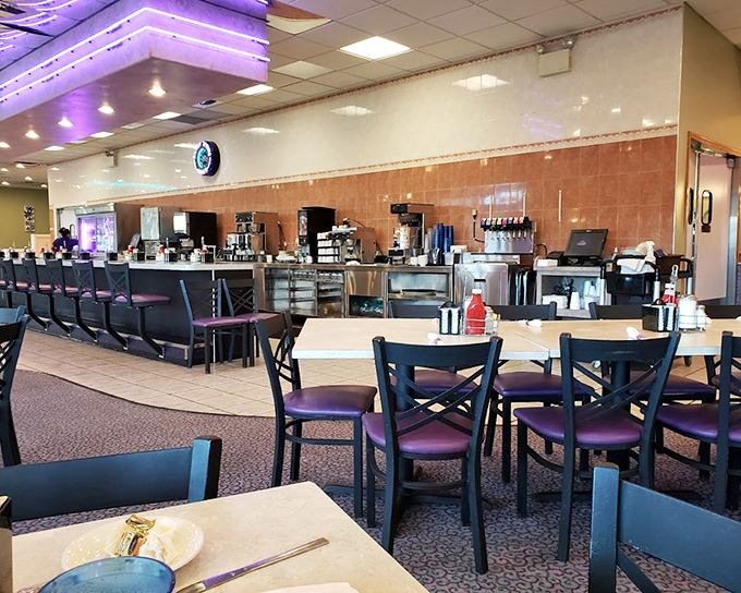 The counter where regulars become family and first-timers become regulars. Purple accent lighting sets the mood for serious eating. 
