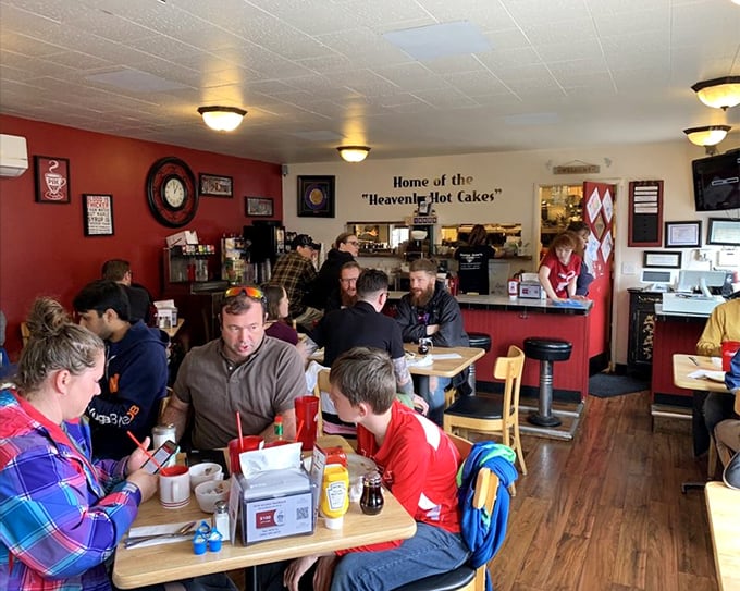 Where strangers become friends over coffee and hotcakes. The wall proudly proclaims "Home of the Heavenly Hot Cakes"—truth in advertising at its finest.