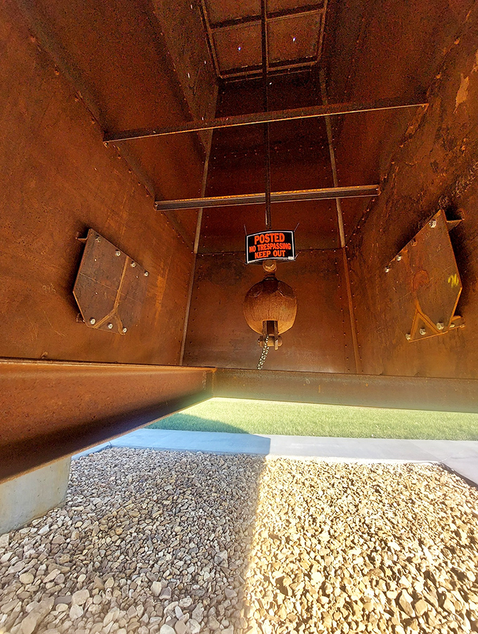 A peek inside reveals the internal structure and a warning sign for anyone tempted to climb.