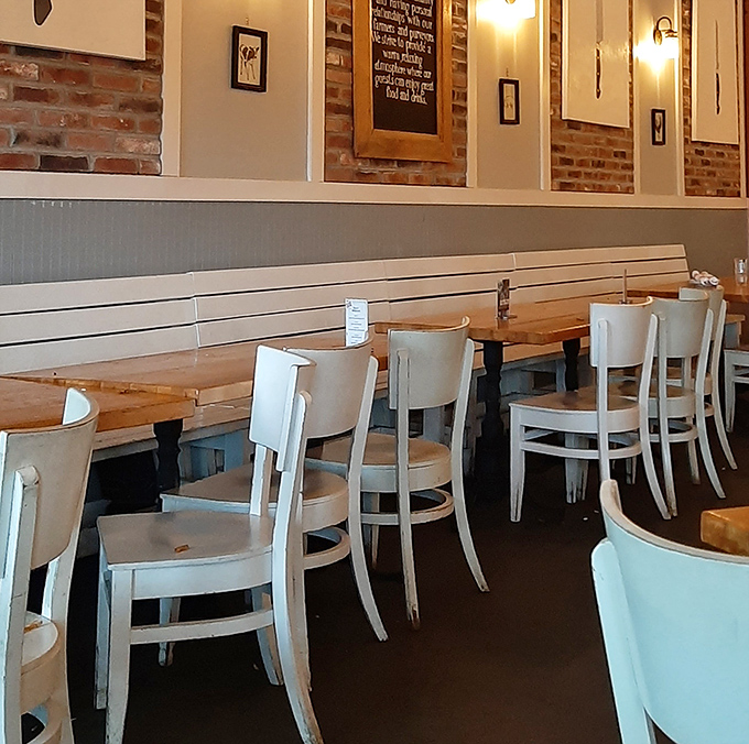 White chairs and wooden accents create a surprisingly elegant atmosphere for a place serving competition-worthy smoked meats.