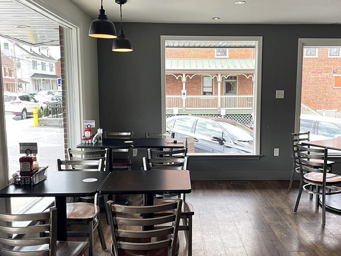 Modern minimalism meets small-town charm. These gray walls and wooden floors create the perfect backdrop for morning revelations over coffee.