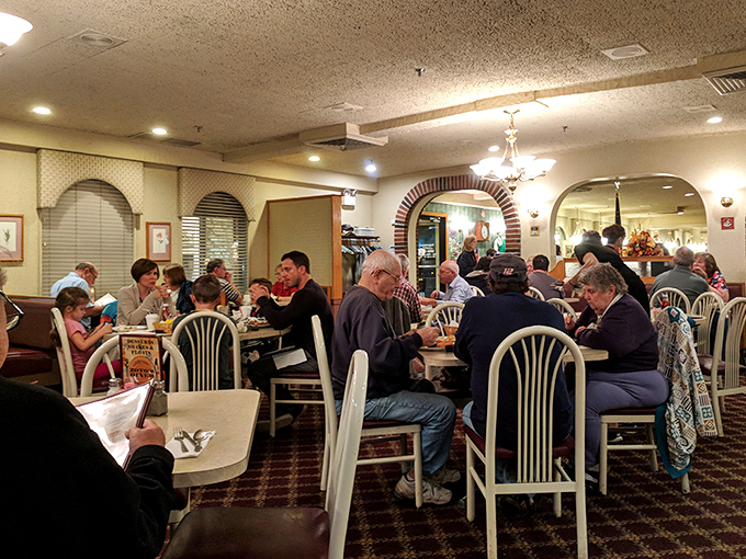 The interior's brick archways and warm lighting create distinct dining areas that somehow feel both spacious and cozy – architectural magic that enhances every bite.
