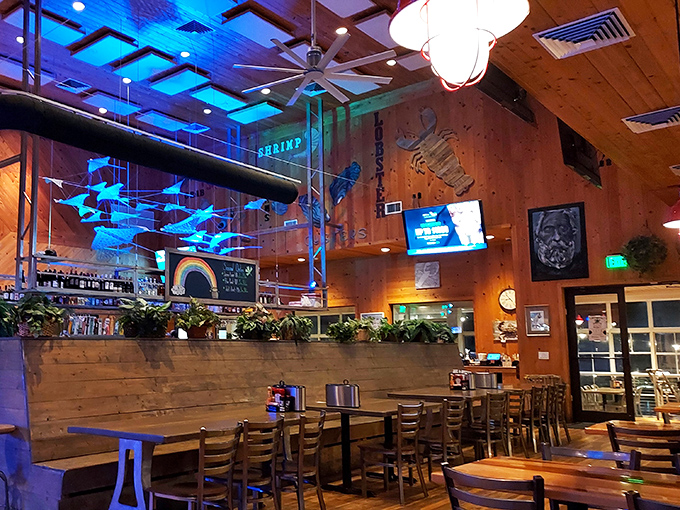 Blue lighting transforms the evening dining room into an underwater fantasy, with fish sculptures swimming through the air above.