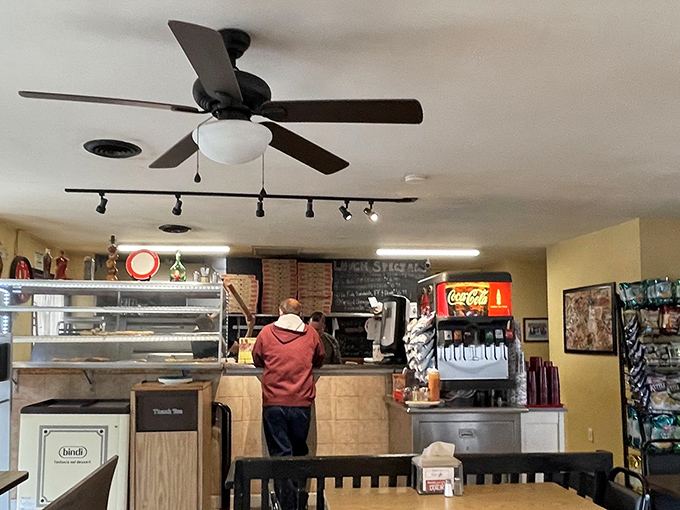 Ceiling fans whirl above while pizza magic happens below. This no-nonsense interior lets the food be the undisputed star of the show.
