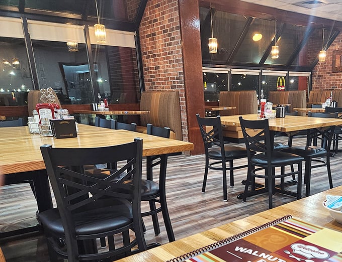 Evening light casts a warm glow across wooden tables where countless conversations have unfolded over plates of comfort food and endless coffee refills.