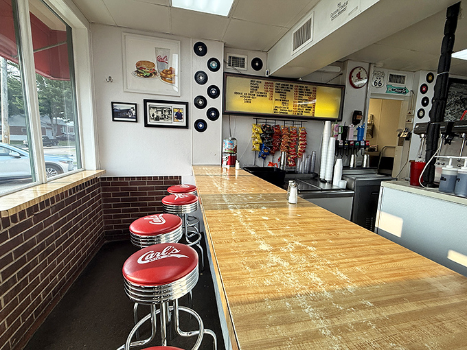 Red vinyl stools await their next occupants in this shrine to American diner culture, where vinyl records on the wall remind us of simpler times.