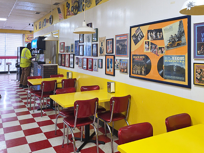 The checkerboard floor says "1950s malt shop," but the memorabilia-covered walls tell stories spanning decades of American pop culture.