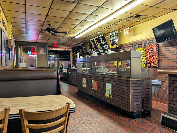 The ordering counter—where dreams come true and diet plans go to die. Note the perfectly worn-in stools that have supported generations of burger enthusiasts.