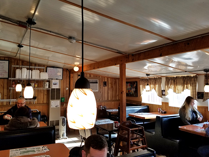Pendant lights cast a warm glow over wooden booths where countless conversations and comfort meals have unfolded over the years.