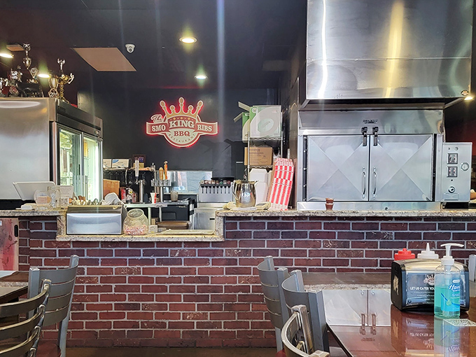 The brick counter and open kitchen layout let you witness the barbecue alchemy. Think of it as dinner and a show.