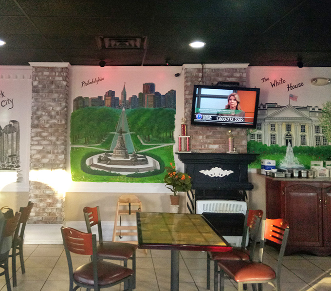 The dining area features murals of Pennsylvania landmarks, creating a patriotic backdrop for the serious business of comfort food consumption.
