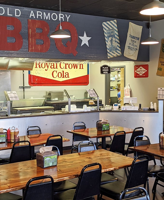 Vintage signs and simple wooden tables create that "we care about BBQ, not fancy furniture" vibe that signals authentic deliciousness.