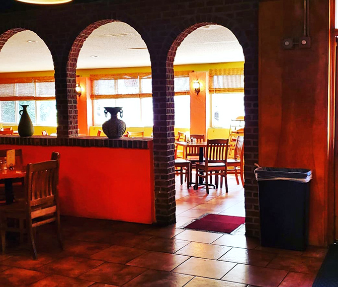 Brick archways frame dining areas like portals to another world. One bite and you'll swear you're overlooking the Aegean Sea.