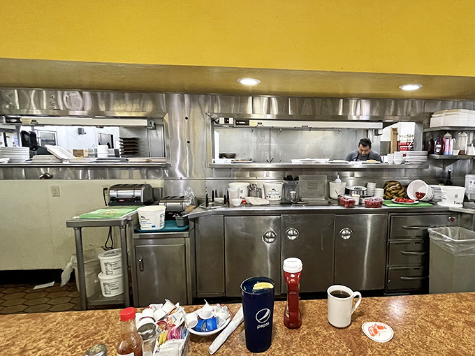 The open kitchen lets you watch breakfast magic happen in real-time, where skilled cooks turn simple ingredients into morning masterpieces daily.