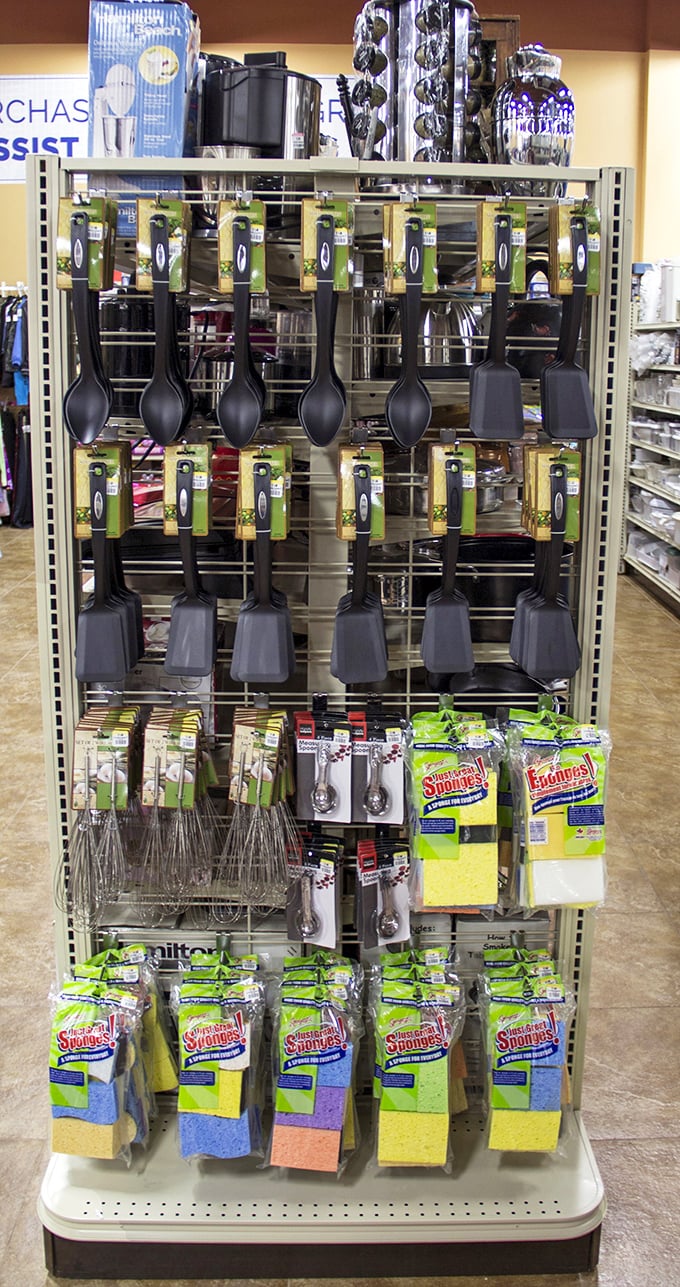 Kitchen utensils and sponges displayed with retail-store precision, proving secondhand shopping doesn't mean settling for chaos and confusion.