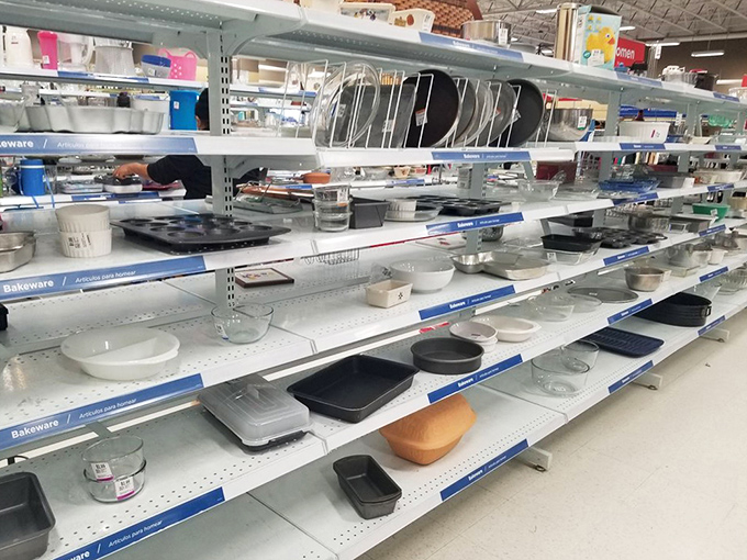 Bakeware shelves lined with kitchen essentials for folks who actually enjoy cooking instead of just microwaving everything frozen. 