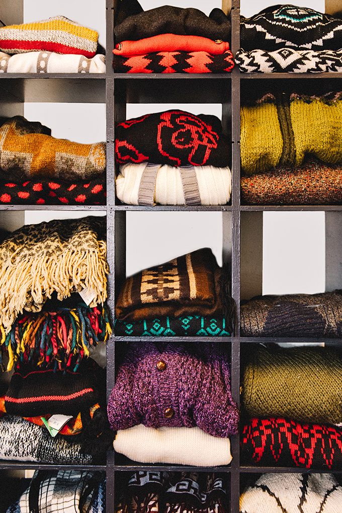 Cozy knits stacked like a textile library. Each sweater pattern tells the story of a different decade's approach to staying warm with style.