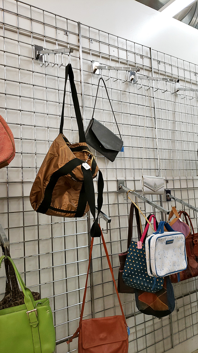 Handbags hang like exotic fruit, ripe for picking. That butter-soft leather tote might have once carried a screenplay to a Broadway producer.